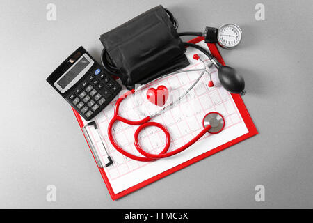 Tonometer with calculator and cardiogram on table Stock Photo - Alamy