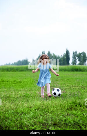 Little girl playing football outdoor Stock Photo - Alamy