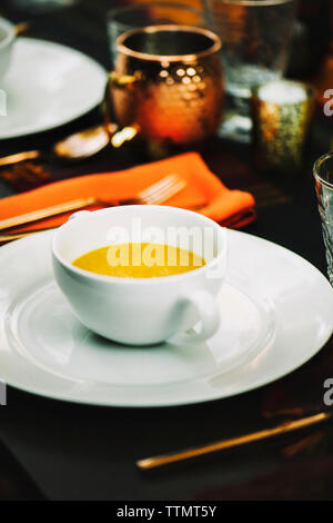 Pumpkin soup in a bowl served with parsley and pumpkin seeds. Vegan ...