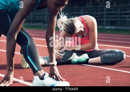 Female Athletes Training on Track Wheelchair Athlete and Hijab-Wearing ...