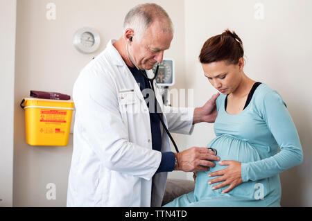 Doctor examining woman's stomach in medical practice Stock Photo - Alamy