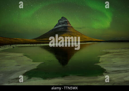 A scenic view of northern lights over Reykjavik Stock Photo - Alamy