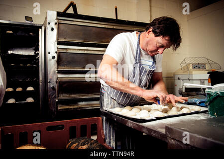 Old male baker working in the kitchen Stock Photo - Alamy
