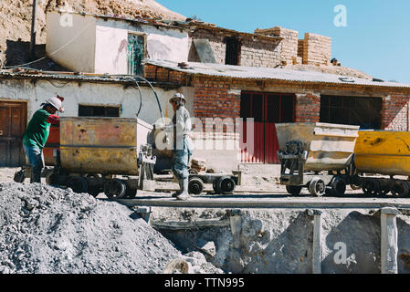 Manual workers working on messy floor at construction site Stock Photo ...