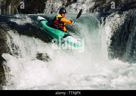Male kayaker paddling through rapids on the River Tryweryn at the ...
