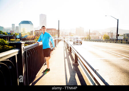 Man stretching while standing against clear sky Stock Photo - Alamy