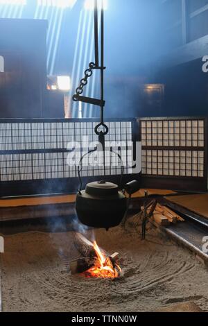 Traditional irori sunken hearth fire pit with kettle in historic Stock ...