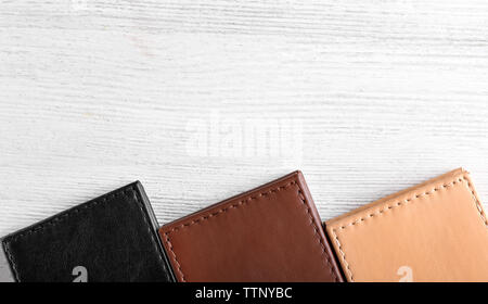 Leather wallets on wooden background Stock Photo - Alamy
