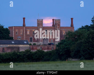 Strawberry full moon rising above golden fields. Image captured from ...