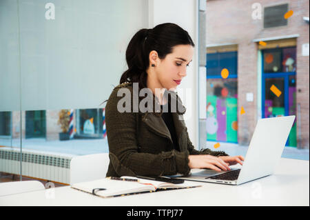 Young beautiful hispanic woman business worker writing on cork board at ...