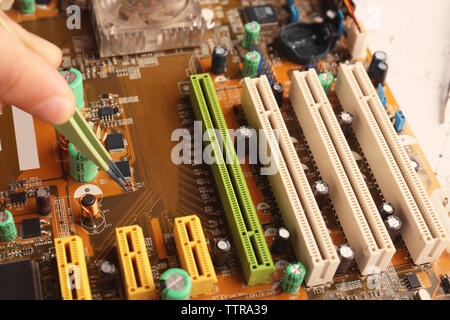 Man repairing motherboard, closeup Stock Photo - Alamy