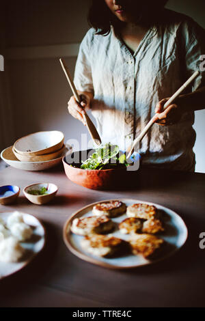 Midsection of female chef preparing vegetable at kitchen Stock Photo ...