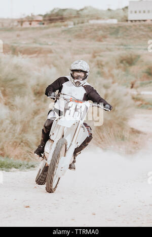 Man driving motorbike stepping on the road very fast Stock Photo - Alamy