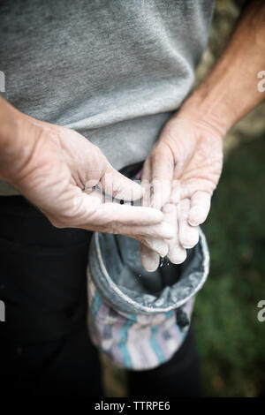 applying magnesium to the hands from the bag before climbing the ...