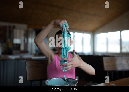Tween siblings making slime at home Stock Photo - Alamy