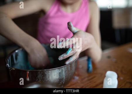 Close-up of kid's hands makes holiday decorations, attaches colorful ...
