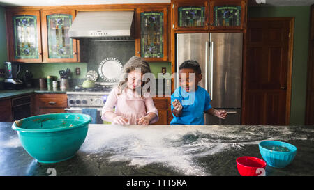 Kids making a mess in the kitchen Stock Photo - Alamy