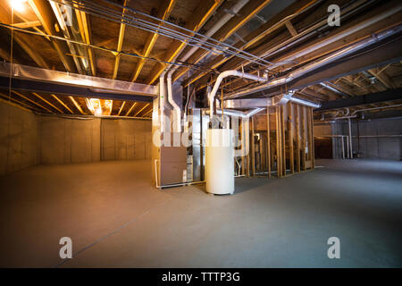 The interior of a factory with machinery manufacturing pipes and rods ...