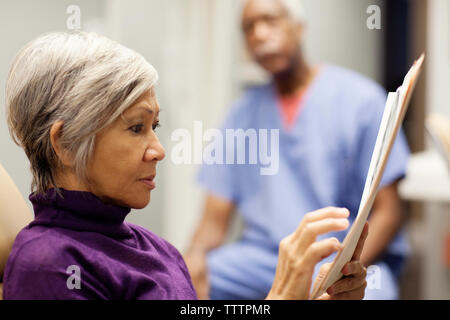 Doctor reading a medical report in office; panoramic banner Stock Photo ...