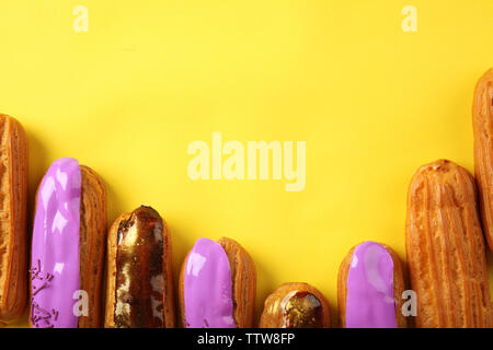 Delicious eclairs on yellow background Stock Photo - Alamy