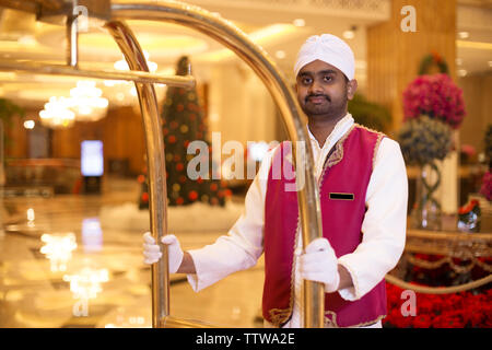 young indian porter service in luxury hotel lobby Stock Photo - Alamy