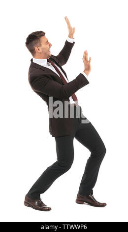 Young businessman pushing invisible obstacles Stock Photo - Alamy