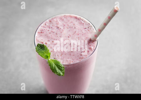 Delicious milkshake on grey textured background Stock Photo - Alamy