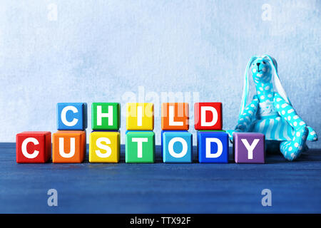 Cubes with text CHILD CUSTODY and toy on light background Stock Photo ...