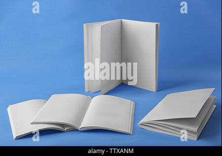 Blank brochures on blue background Stock Photo - Alamy