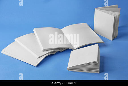 Blank brochures on blue background Stock Photo - Alamy
