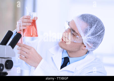 Young male scientist making experiments in laboratory Stock Photo - Alamy