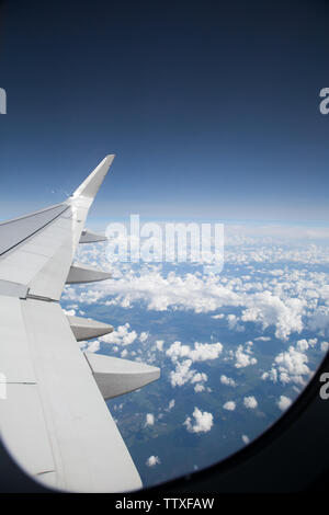 View from the airplane window at a beautiful cloudy sky and the ...