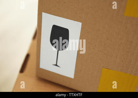 Carton boxes with warning sign, closeup Stock Photo - Alamy