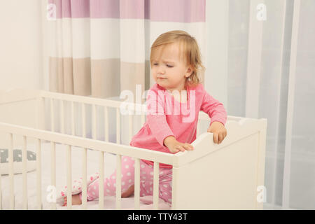 A Cute little girl in cradle at baby room Stock Photo - Alamy