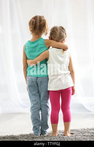 Cute sisters standing near window at home Stock Photo - Alamy