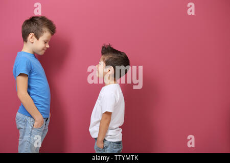 Cute little brothers standing on yellow background Stock Photo - Alamy
