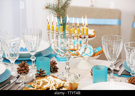 Table setting for Hanukkah Jewish holiday. Plate and cutlery on a white ...