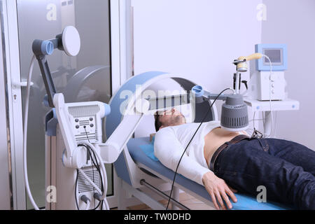 inductive shortwave diathermy for young man in modern clinic Stock ...