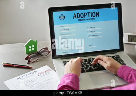 Woman filling adoption paternity registry in tablet Stock Photo - Alamy