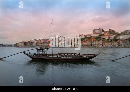 Traditional wine boat, Ribeira embankment in bakground, Dom Luis bridge ...