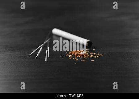 Acupuncture needles with cigarette on dark background Stock Photo - Alamy