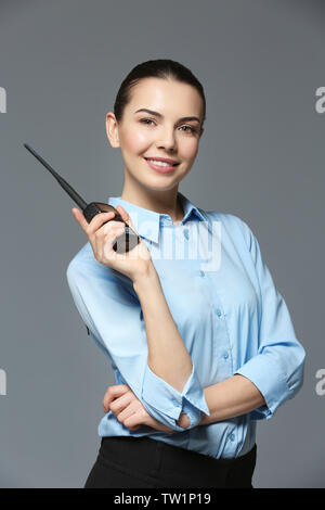 Beautiful security guard on grey background Stock Photo - Alamy