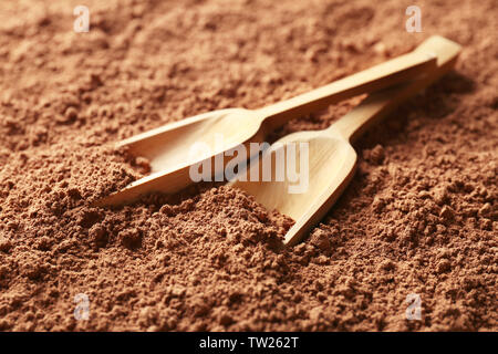 Wooden scoops on cocoa powder background Stock Photo - Alamy