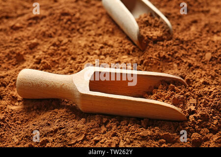Wooden scoops on cocoa powder background Stock Photo - Alamy