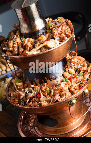 Charcoal fire frog pot field chicken meal Stock Photo - Alamy