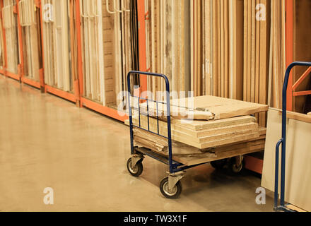 Wooden boards on cargo cart in storehouse Stock Photo - Alamy