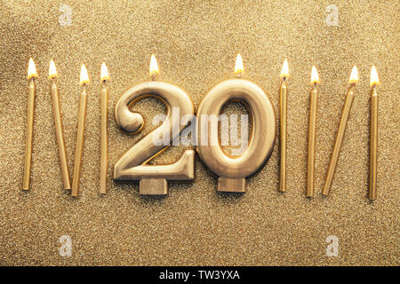 Number 20 gold celebration candle on star and glitter background Stock ...