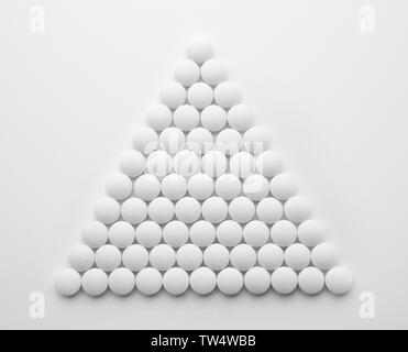 Triangle made of pills on white background Stock Photo - Alamy