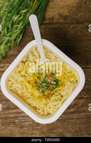 instant noodles on an old wooden table top view Stock Photo - Alamy