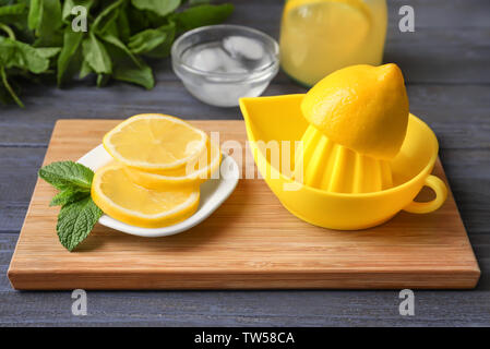 Composition with lemon squeezer on table in kitchen Stock Photo - Alamy